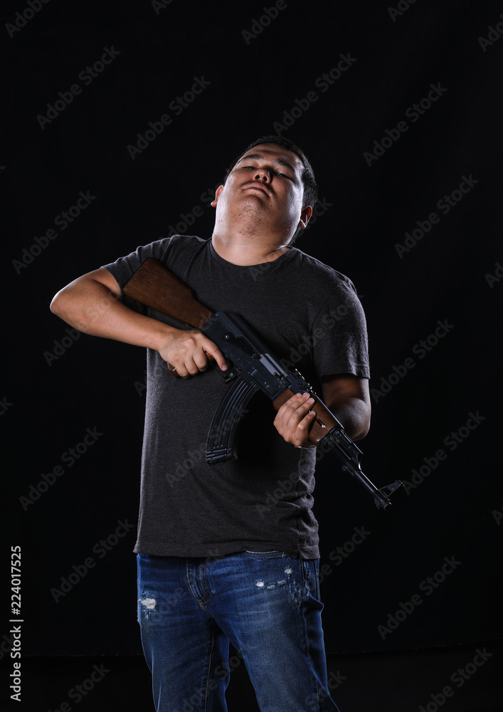 asian guy with a gun Stock Photo | Adobe Stock