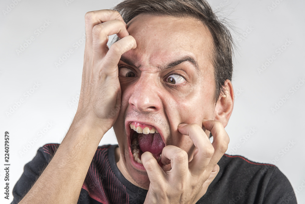 Young angry and frustrated man about to explode, raging and shouting ...