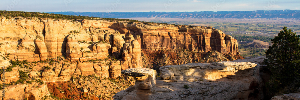 Early-morning light on the massive 300' high Wingate Sandstone walls of ...