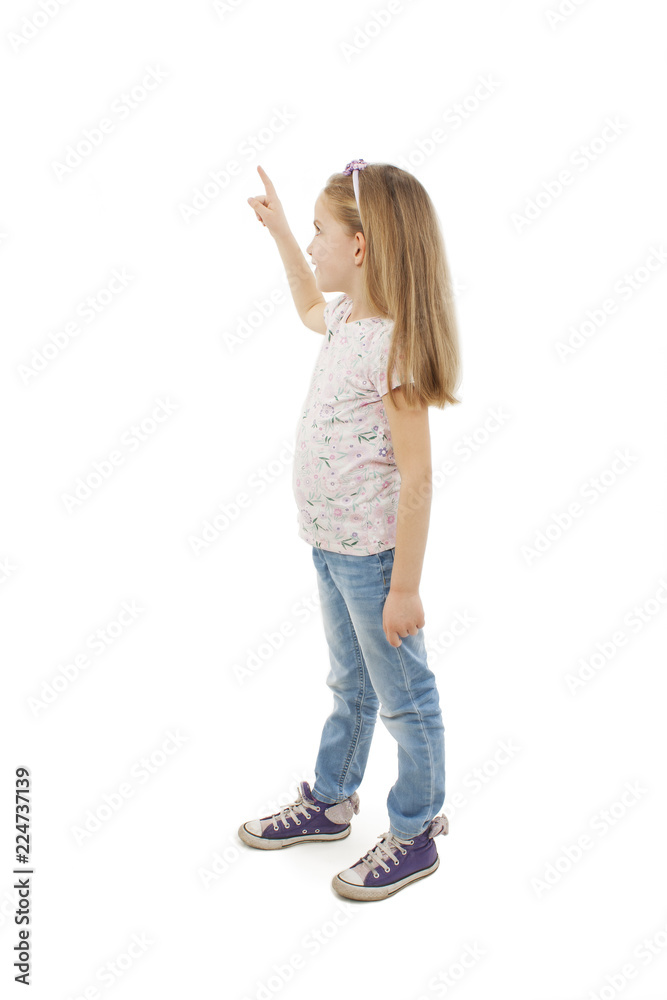 Adorable little girl pointing at wall. Isolated on white background ...