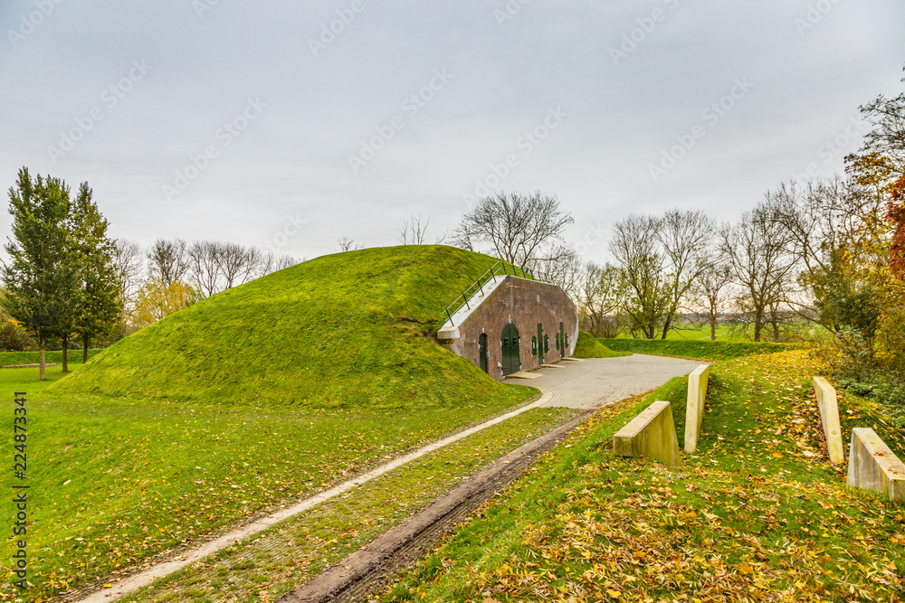 Earthen fortifications with concrete bunkers and Concrete barracks with ...