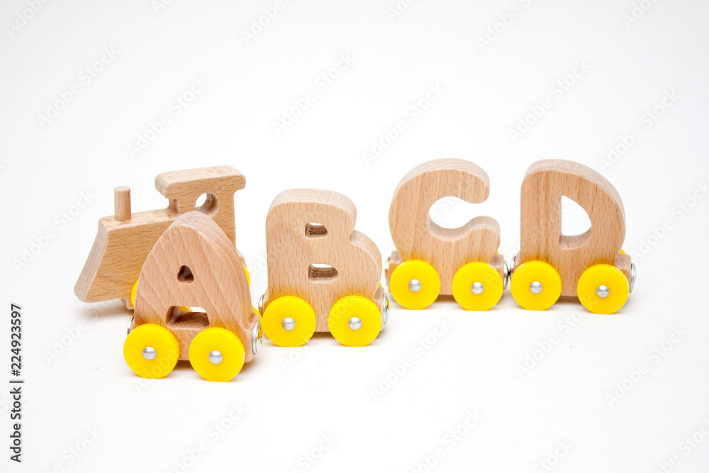 Wooden Letters A, B, C, D of a train alphabet and locomotive with ...