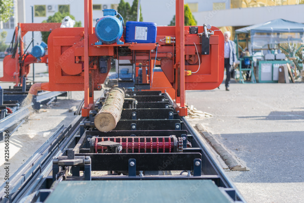 Partially milled log on a portable lumber milling machine. Stock Photo ...