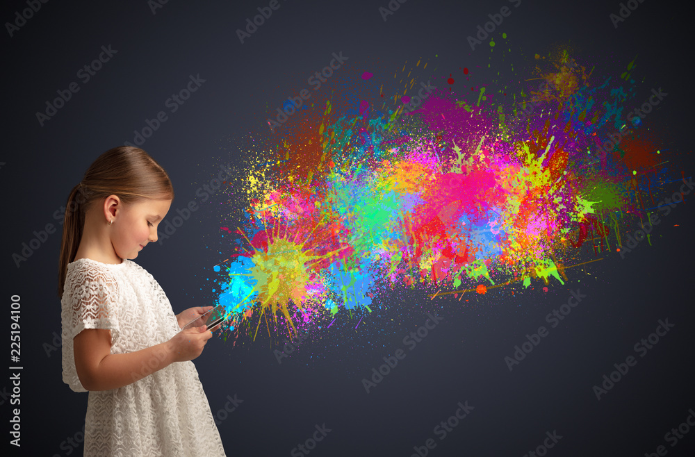 Cute little girl using tablet with colourful splash concept Stock Photo ...
