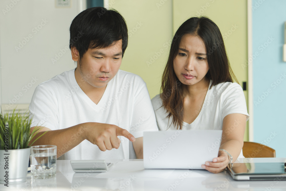 Family financial crisis. Stressed young asian couple looking at issues ...