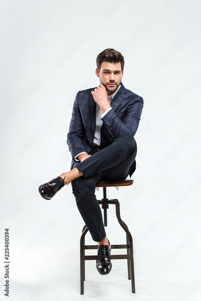 Elegant and handsome. Full length of handsome young man looking at ...