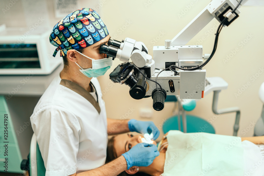 Dentist examine oral cavity of female patient with microscope. Stock ...