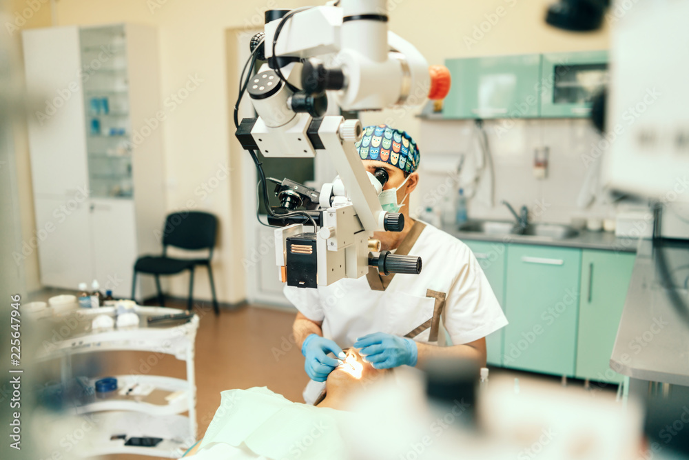 Dentist examine oral cavity of female patient with microscope. Stock ...