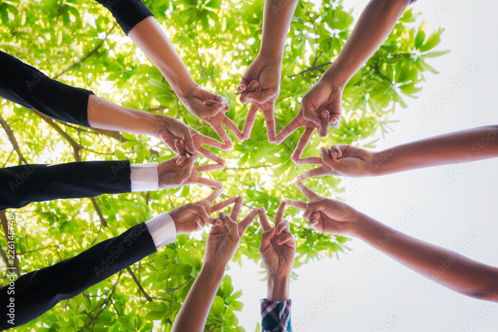 Teamwork putting their hands together,business team with stack of them ...