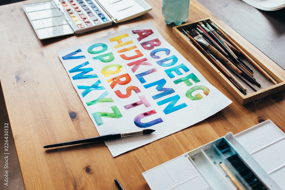 Painter workplace. Wooden table of an artist with art tools for drawing ...