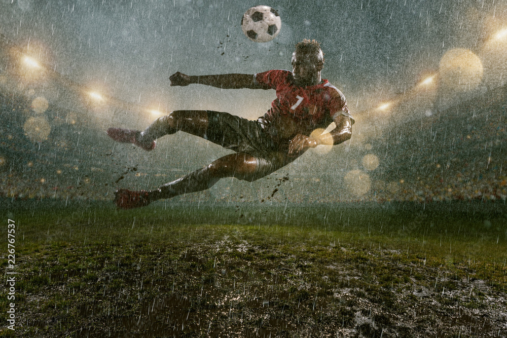 Soccer player on professional soccer night rain stadium. Dirty player ...