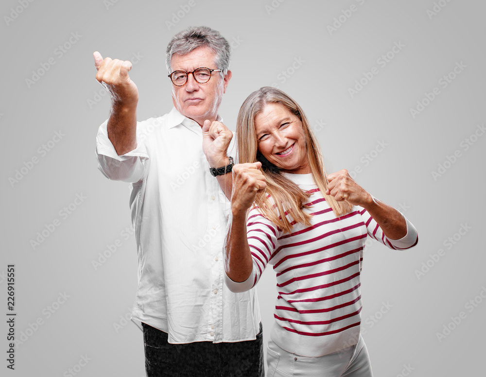 senior cool husband and wife with an angry, aggressive and menacing ...