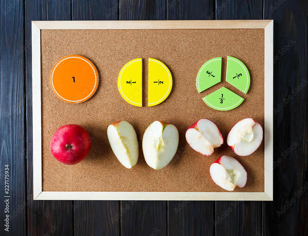 colorful math fractions on brown wooden background or table ...