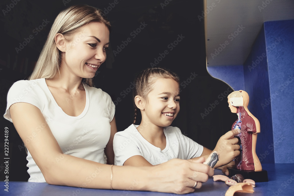 Stock-Foto „Female private tutor helping young student with homework at ...
