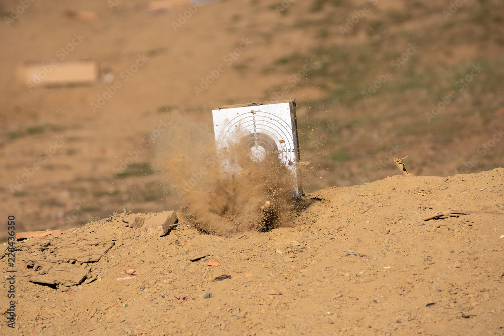 Target practice aim at the outdoor range. Bullet hits the ground ...