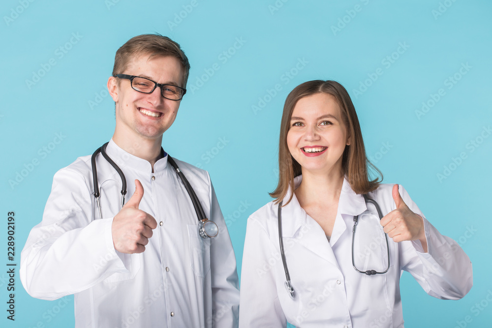 Two best smart professional smiling doctors workers in white coats ...