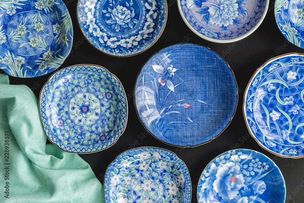 Blue and white decorative Japanese plates on black background - Top ...