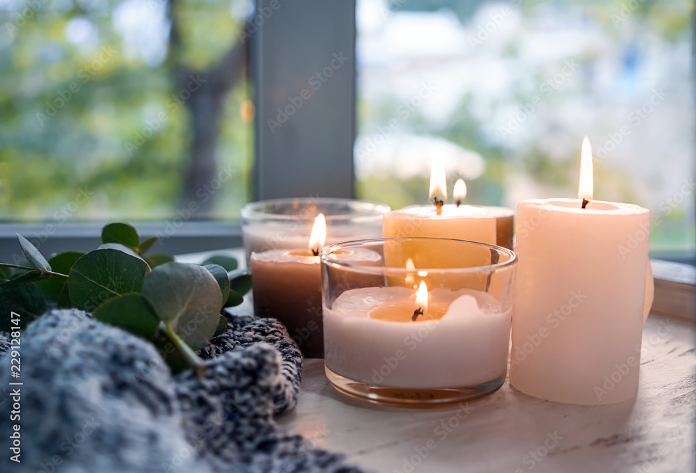 Beautiful burning candles on wooden table Stock Photo | Adobe Stock
