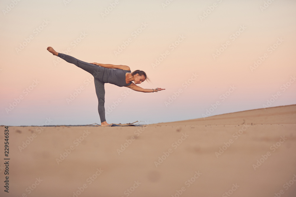 Beautiful young woman practices yoga asana Ardha Chandrasana - Half ...
