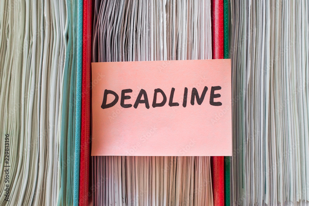 Deadline. Records management. Thick folders with documents on which a ...