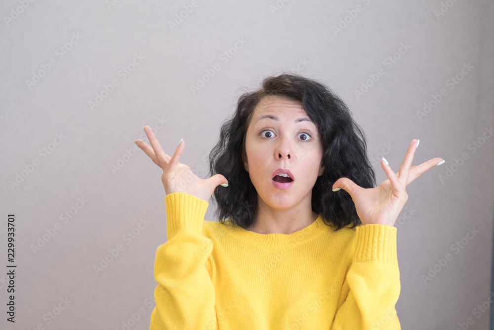head portrait of young beautiful Spanish surprised woman amazed in shock and surprise with mouth ...