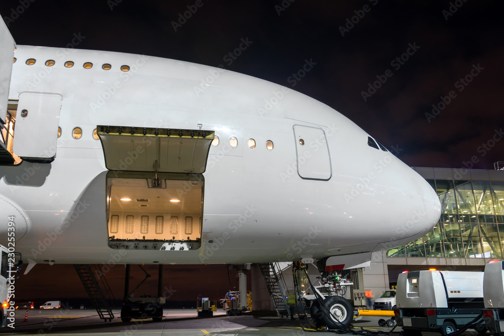Nose and cockpit airplane with open luggage compartment at passenger ...