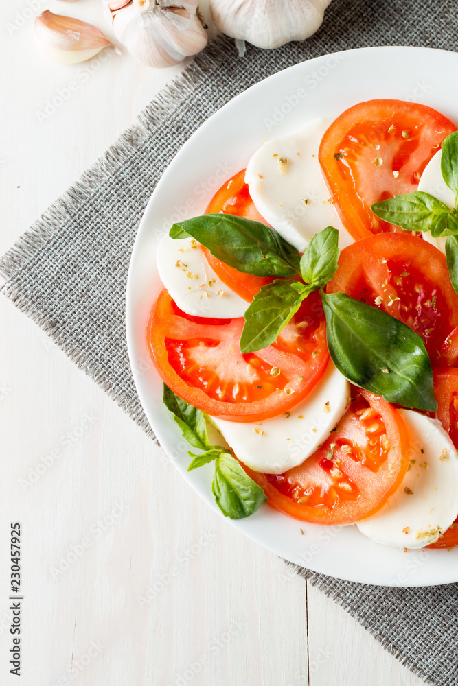 Close-up photo of caprese salad with ripe tomatoes, basil, buffalo ...