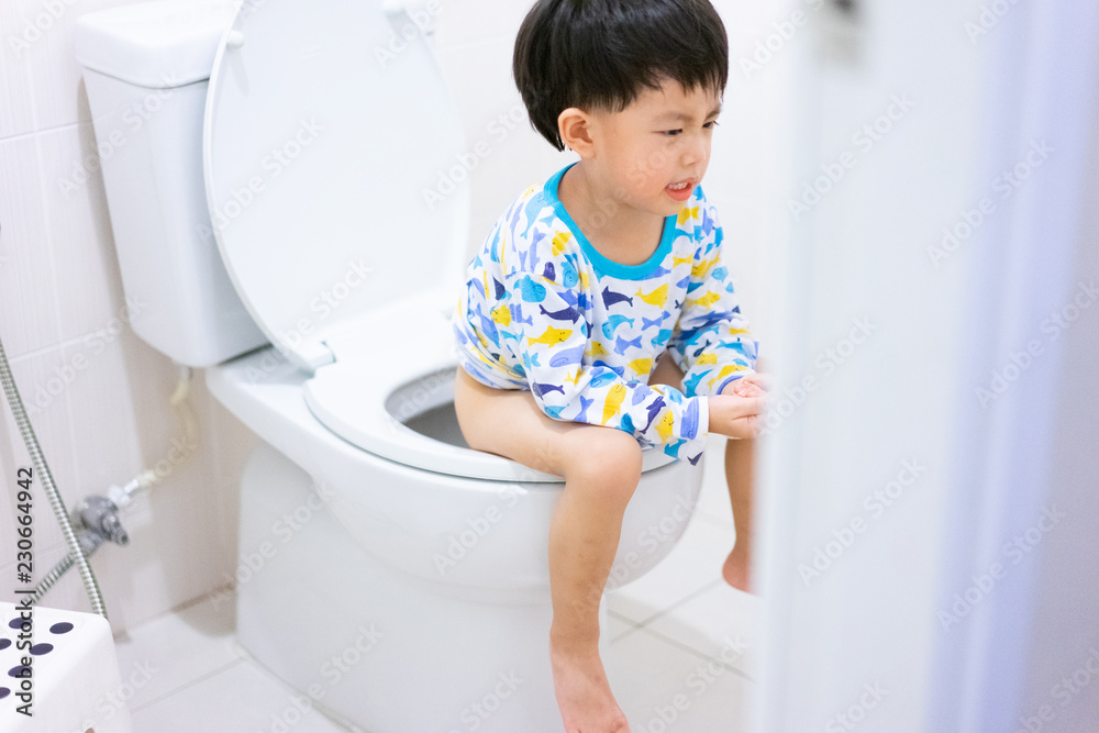 Little boy poo and pee in white toilet. Stock Photo | Adobe Stock