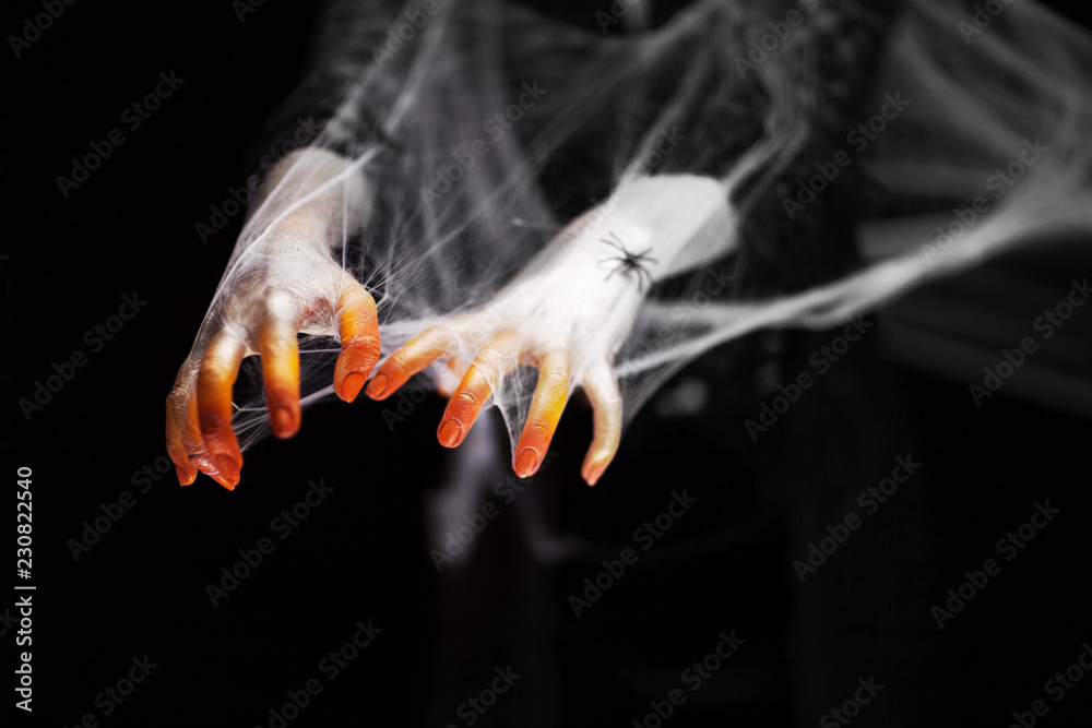 Creepy halloween hands with red, orange and silver covered in a spider ...