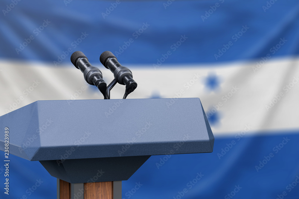 Podium lectern with two microphones and Honduras flag in background ...