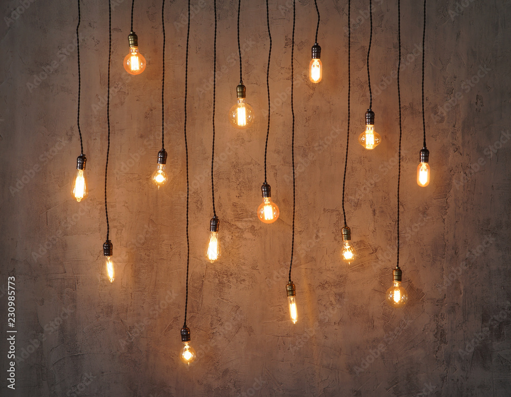 Edison light bulb background. Vintage lamps over concrete background ...
