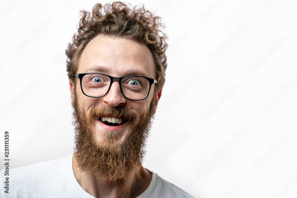 surprised bearded man in spectacles, looks with bated breath and ...