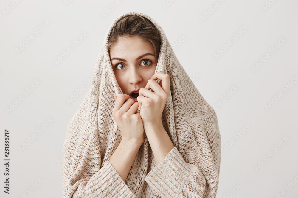 Girl watches horror film alone, trembling from fear. Portrait of ...