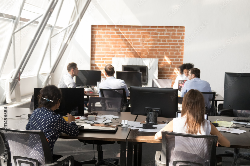 Workers using computers working at modern big open space, company staff ...