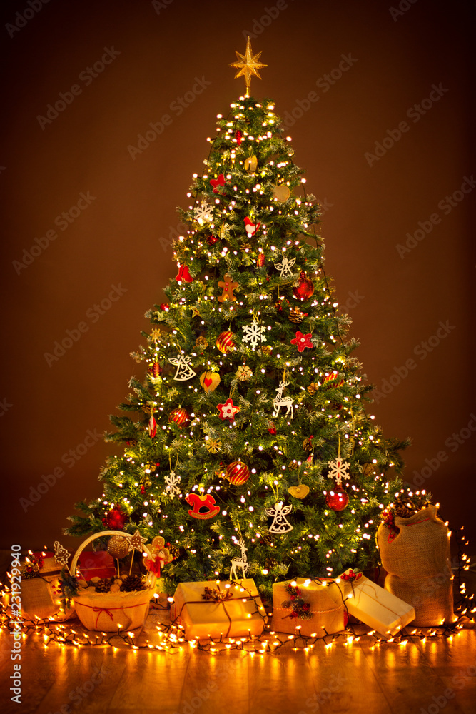 Christmas Tree lighting in night Xmas Decorations Hanging on Chritmastree Star Top Light and Present Gifts Adobe Stock