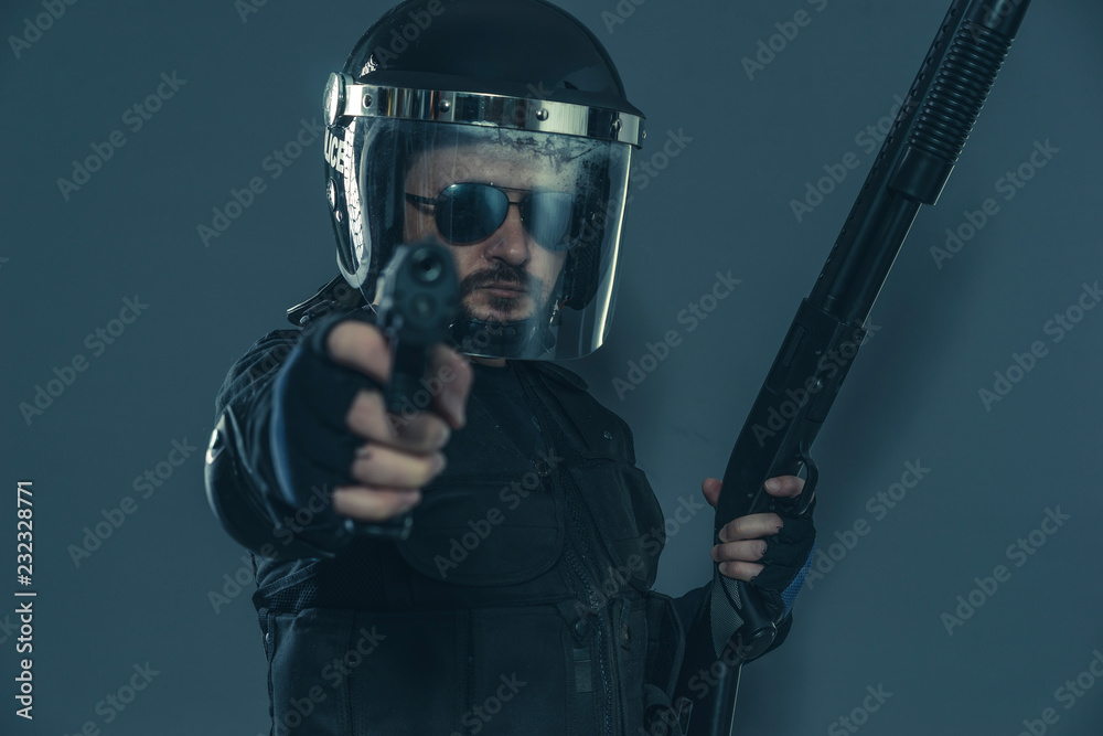 Guard, riot police signaling to colleagues with their hands. armed man ...