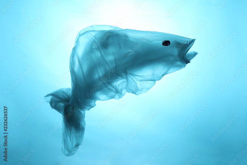 Pollution of the world's oceans with plastic garbage. Blue fish out of ...