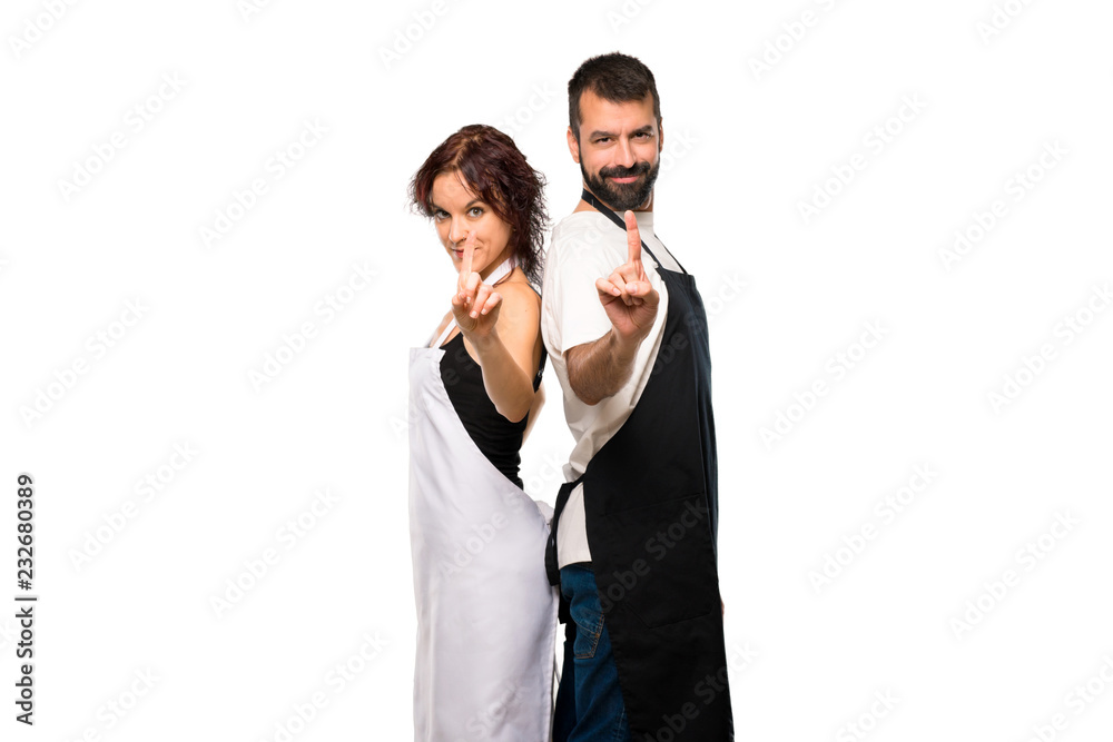 Couple of cooks showing and lifting a finger in sign of the best on ...