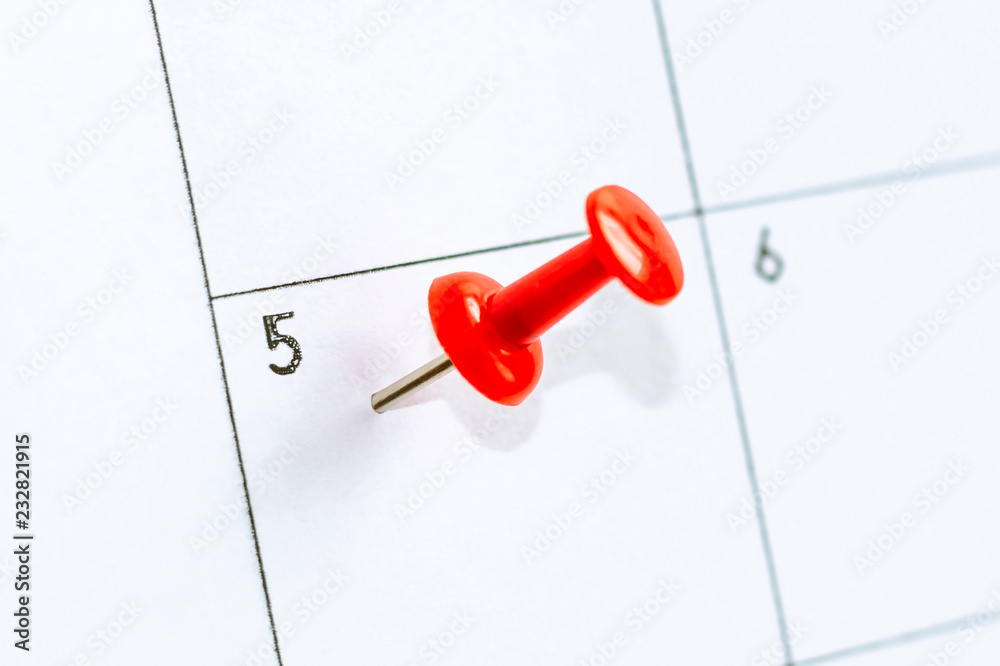 5 date on calendar. fifth day of month is marked with red thumbtack ...