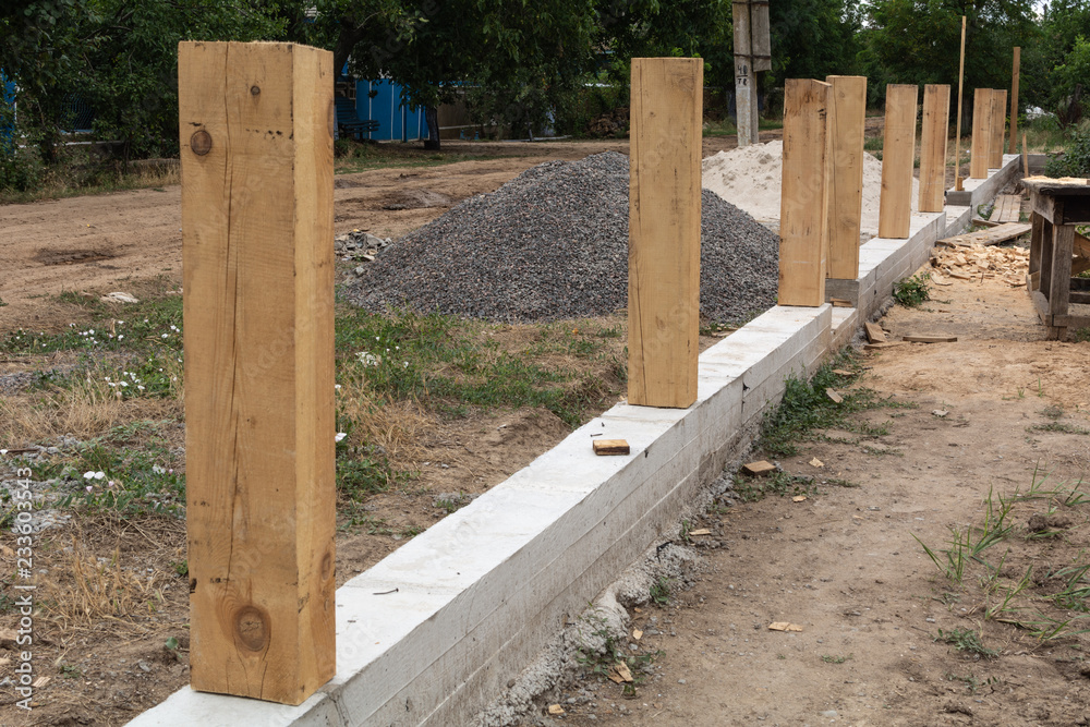 Concrete foundation for fence. Production of the concrete base for a ...