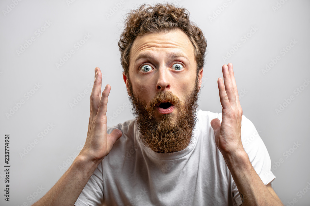 Emotional surprised bearded man looks with bated breath and shocked ...