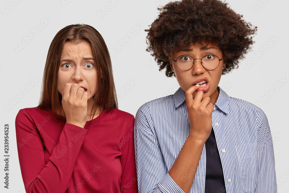 Nervous anxious two women bite finger nails with anxiety, worry about ...