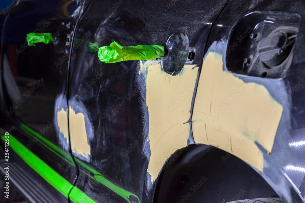 Repair of car body parts in black after an accident and scratches by ...