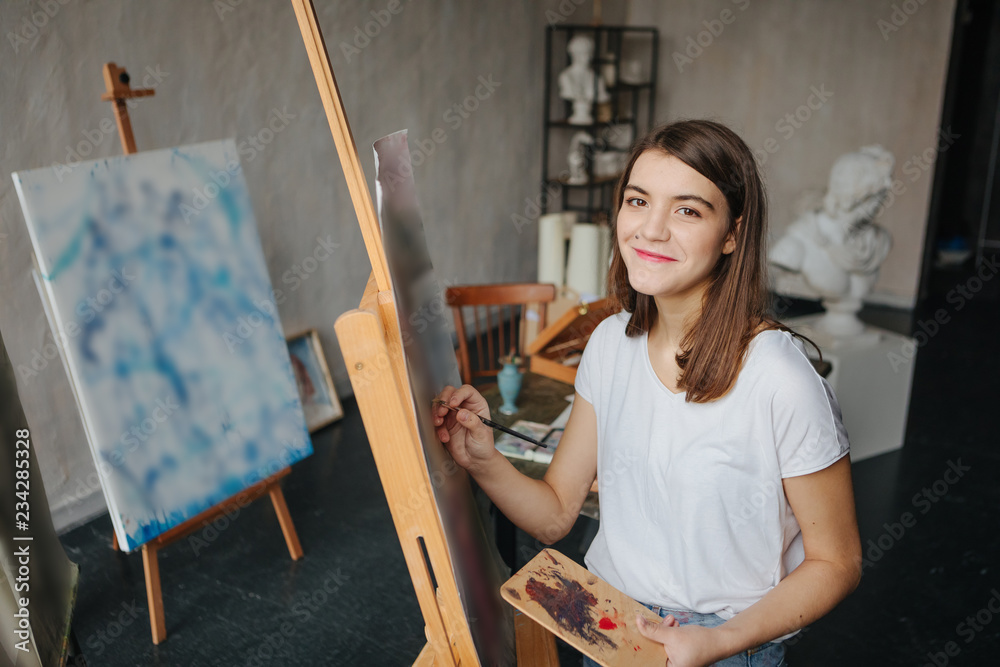 Happy smiling Artist painter young beautiful girl. Working creating ...