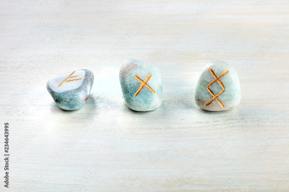 A closeup of ancient Norse runes from the Futhark alphabet, stones with ...