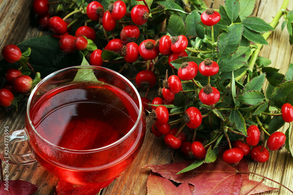 Tea. cup of herbal Dog rose tea with bunch branch Rosehips, types Rosa ...