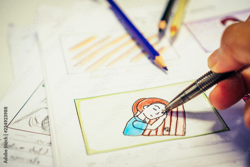Designer drawing Story board movie video layout for pre-production ...