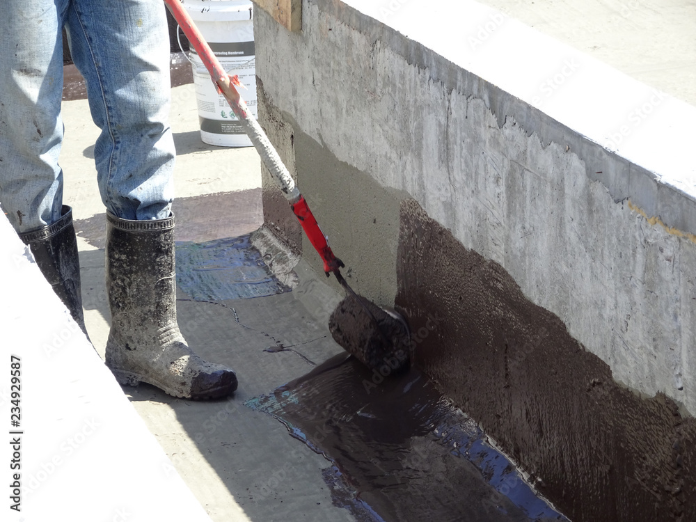 Waterproofing membrane applied by construction workers on top of ...