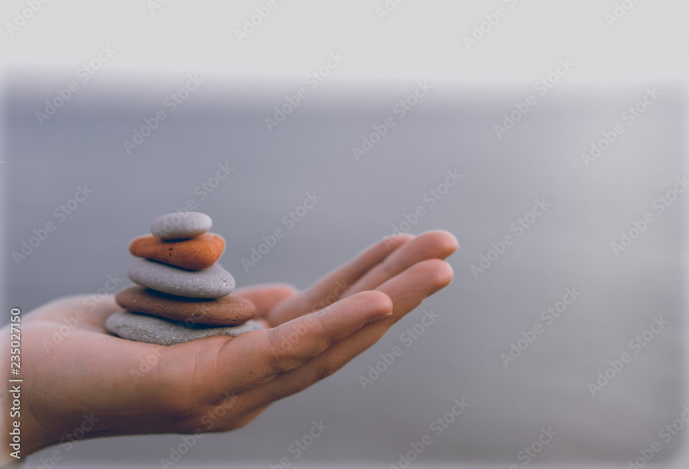 Pile of stacked stones in human hand Stock Photo | Adobe Stock
