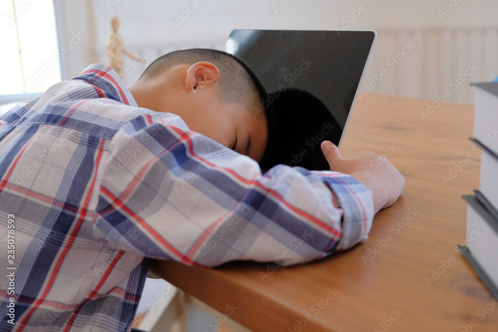 lazy stressed young little asian kid boy resting sleeping on desk ...